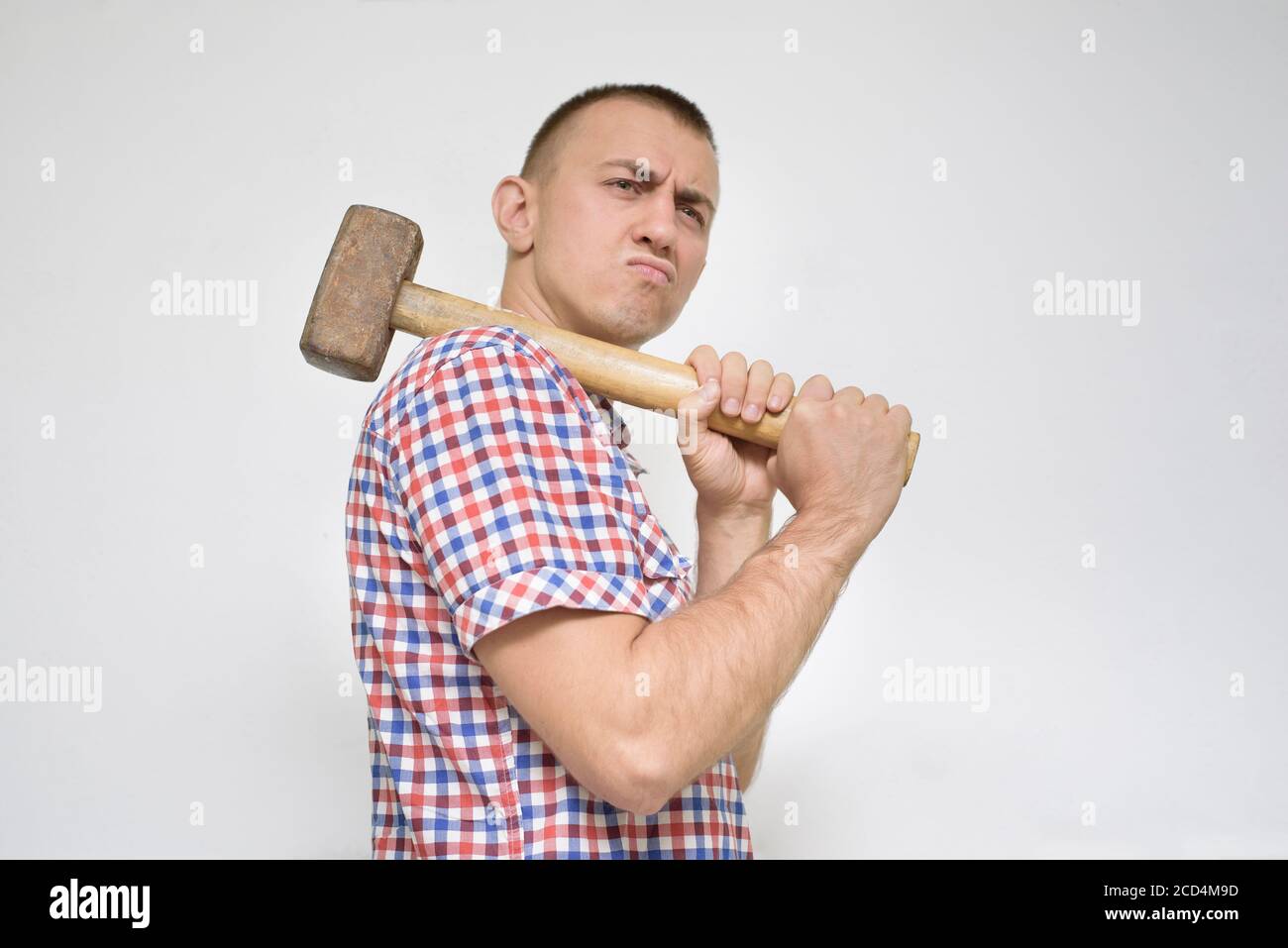 Man with a sledgehammer on a white background. Work concept Stock Photo ...