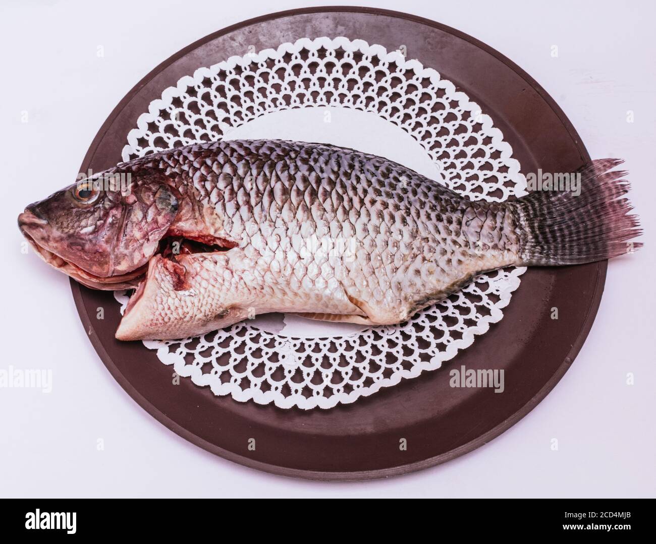 Top view of an uncooked fish on a plate Stock Photo - Alamy