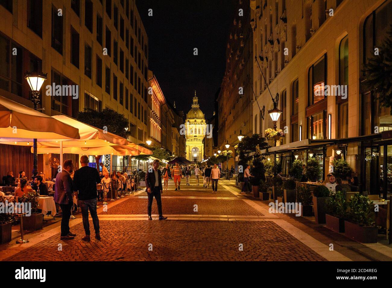 People walking on Zrinyi utca with Saint Stephen's Basilica in the ...