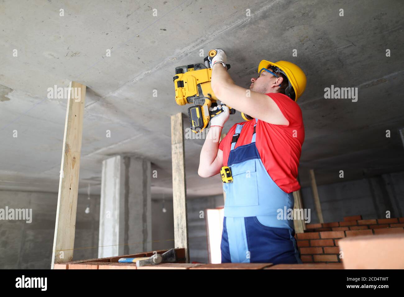 Builder works with special equipment on ceiling Stock Photo - Alamy