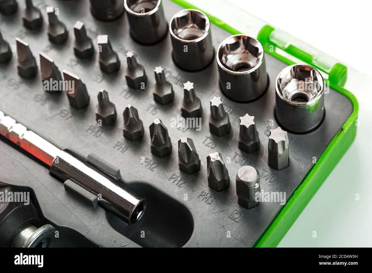 Tool box with attachments and bits of different shapes and sizes close ...