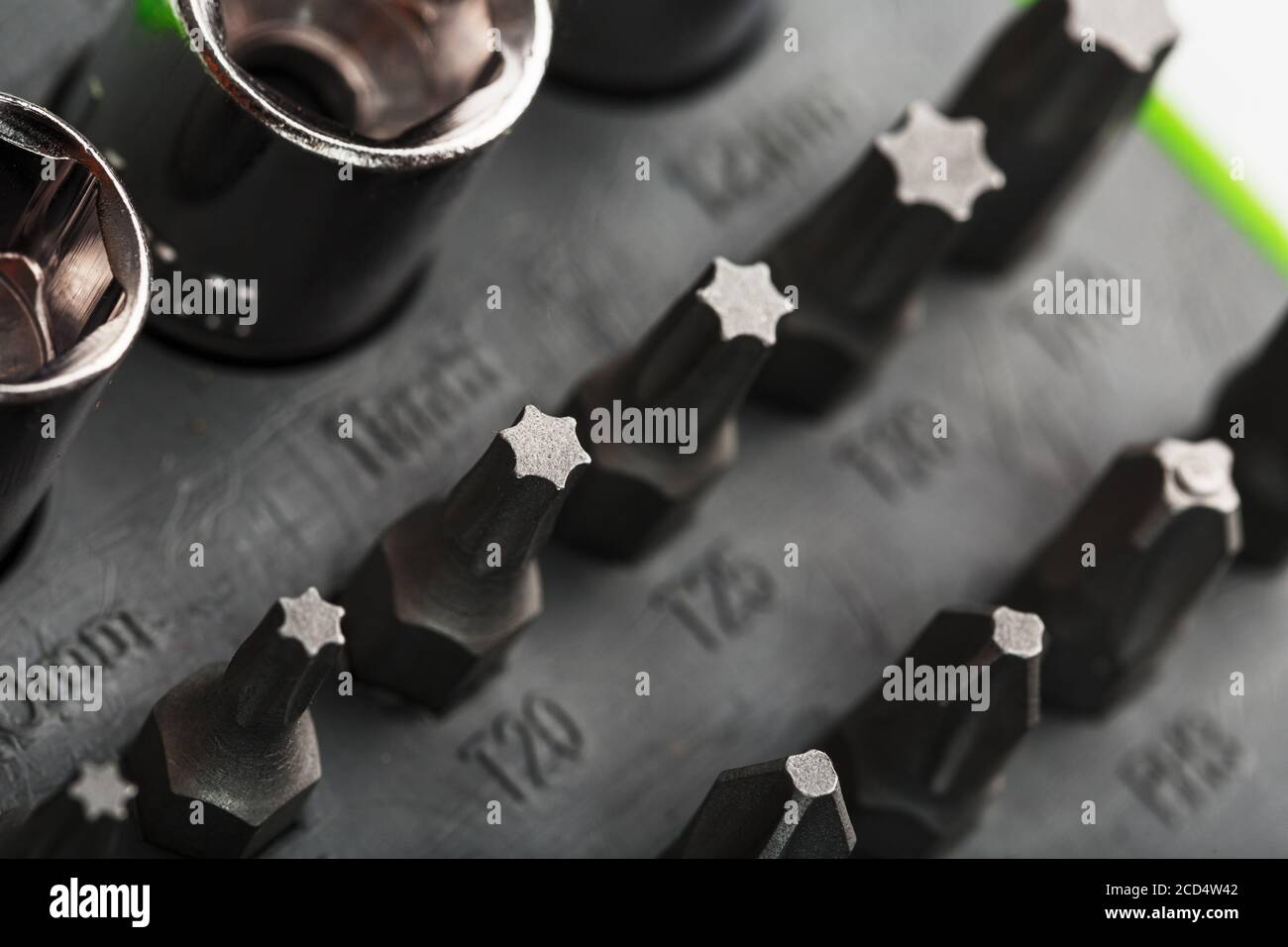 Tool box with attachments and bits of different shapes and sizes close ...