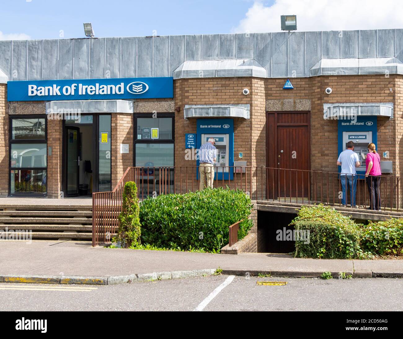 People using ATM at Bank Of Ireland Stock Photo - Alamy