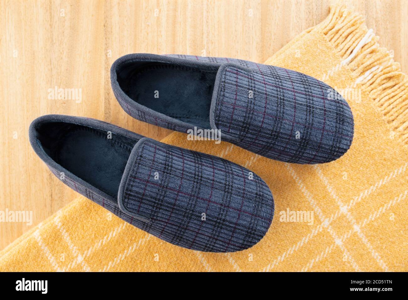 Male home slippers and wool blanket on table. Home relaxing in ...