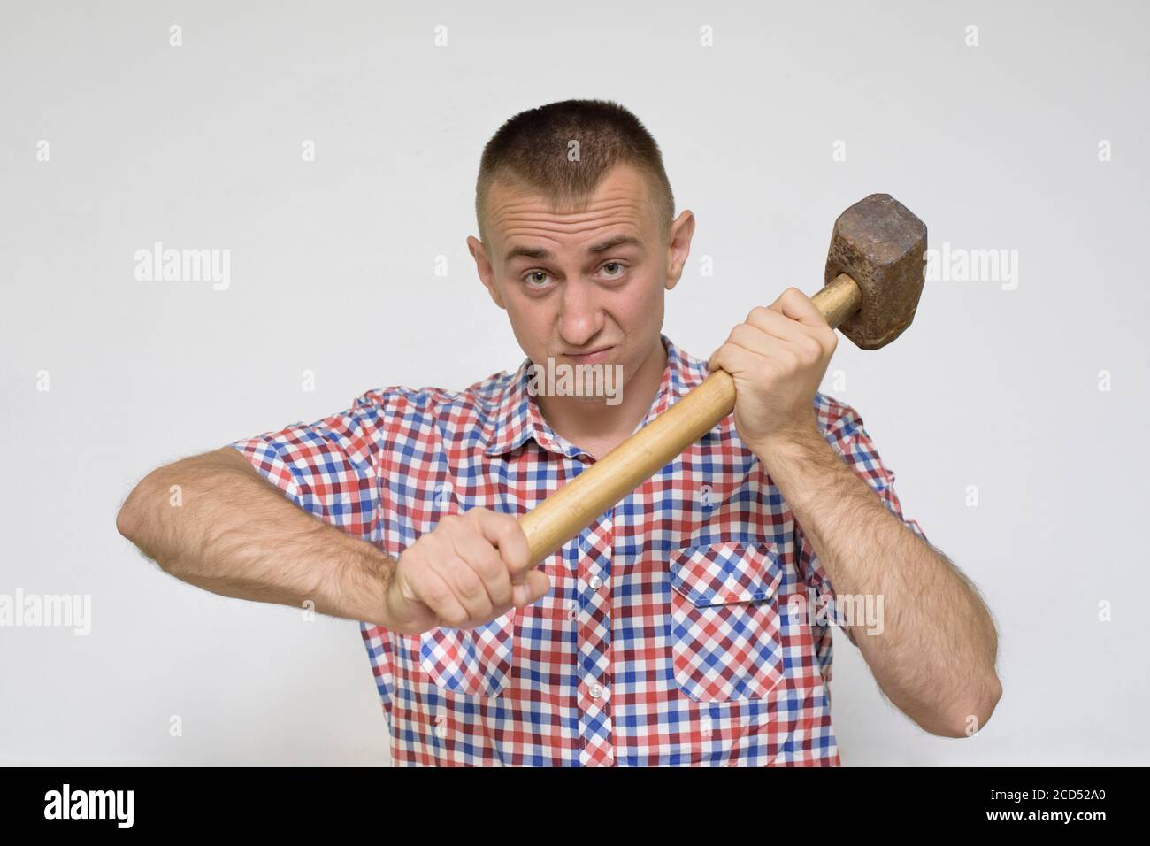 Man with a sledgehammer on a white background. Work concept Stock Photo ...