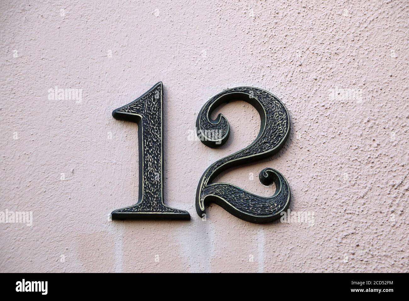 Closeup shot of number 12 on a concrete wall Stock Photo - Alamy