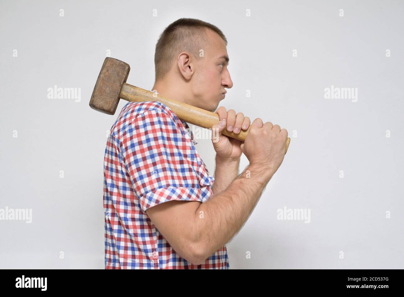 Man with a sledgehammer on a white background. Work concept Stock Photo ...