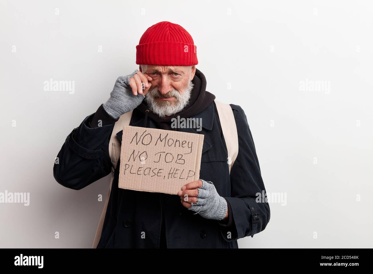 Homeless man holding sign, request for help, seeking help posing at ...