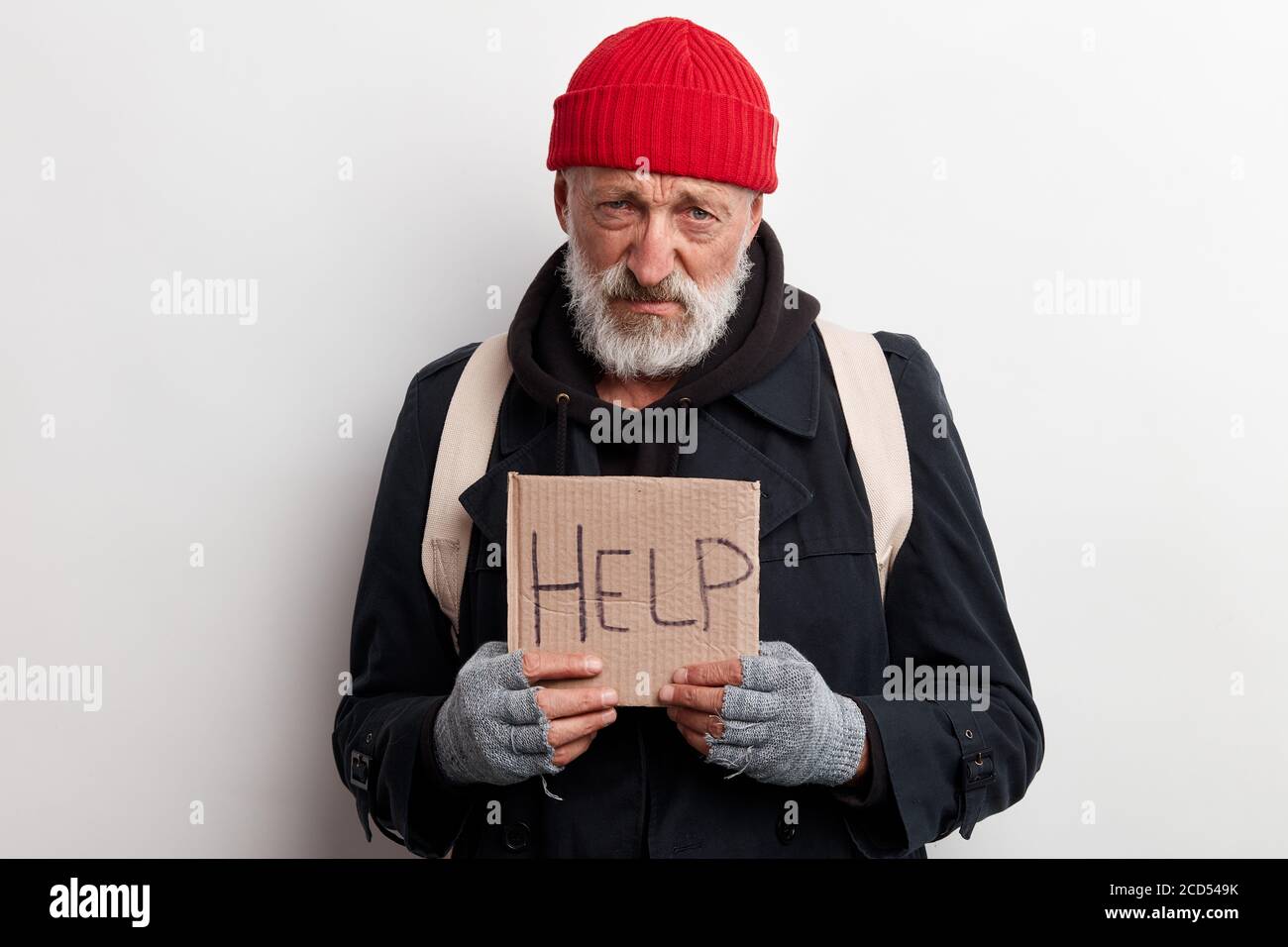 Homeless man holding sign, request for help, seeking help posing at ...