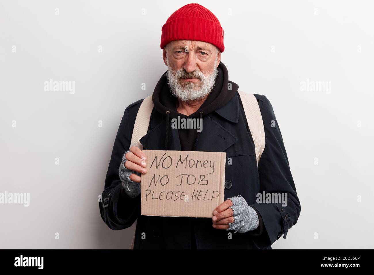 Homeless man holding sign, request for help, seeking help posing at ...