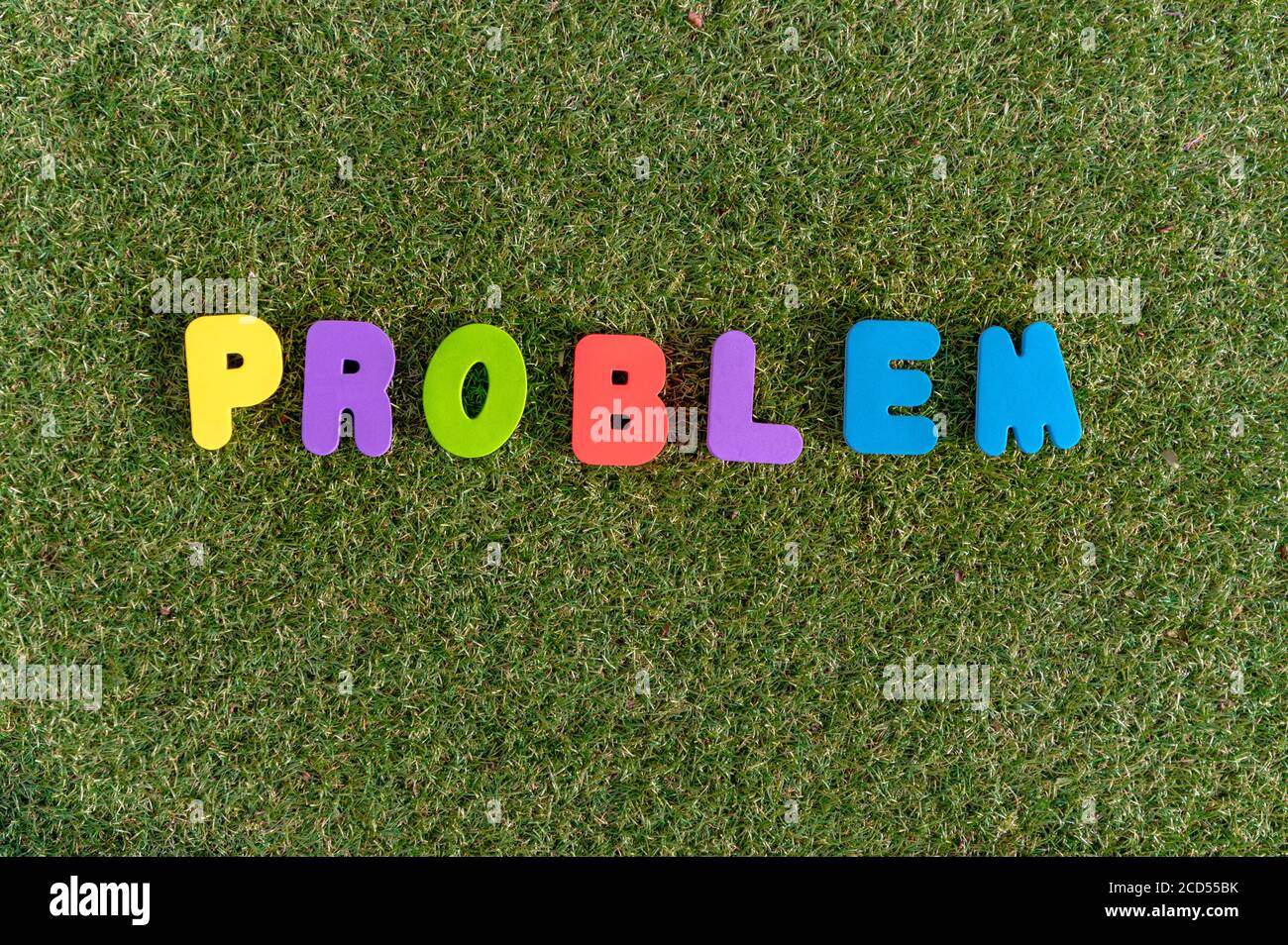 Capital letter "problem" word from colorful of wood on grass background ...