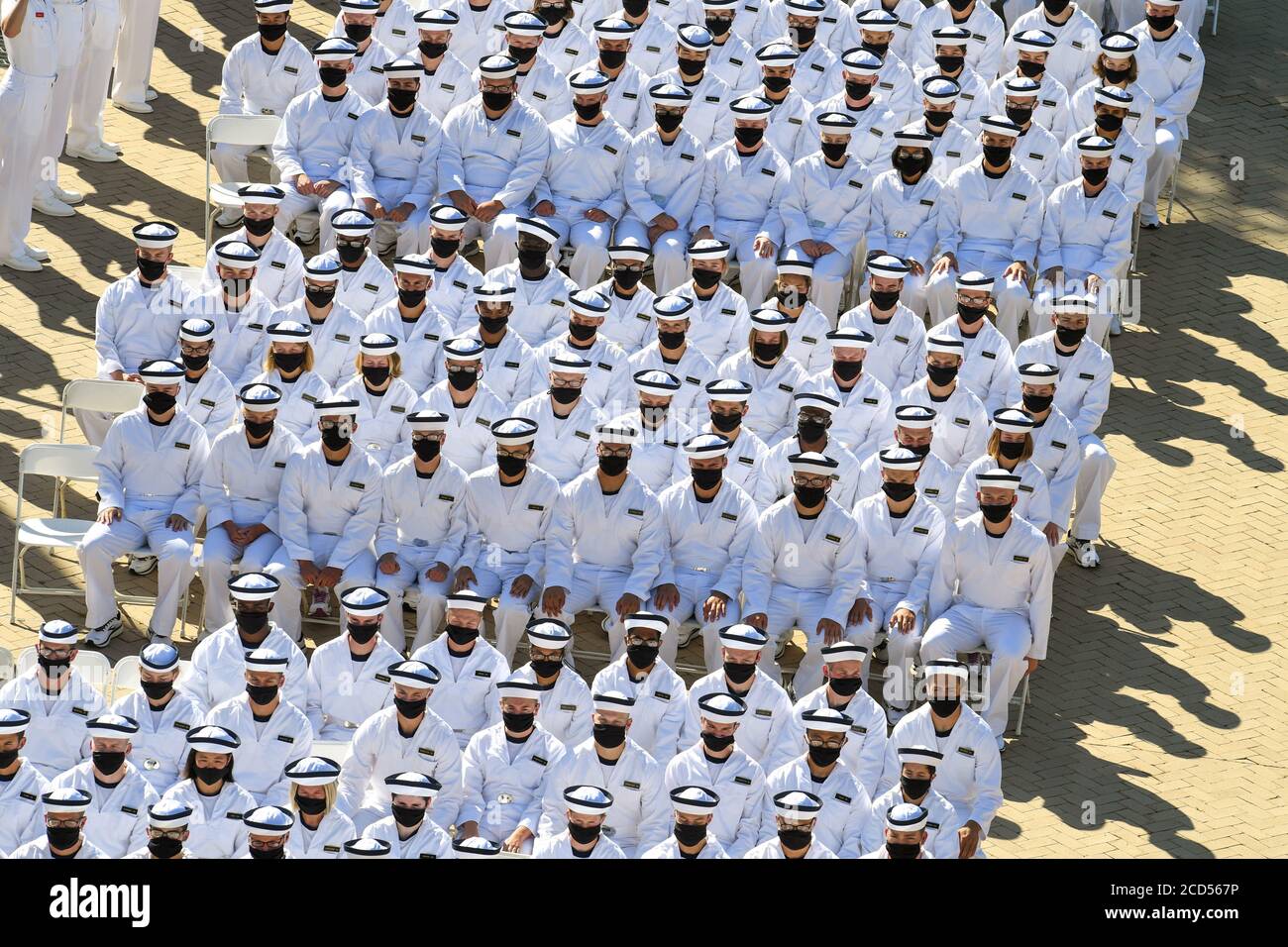 U.S. Naval Academy Navy midshipmen, wear PPE masks during the Oath of ...