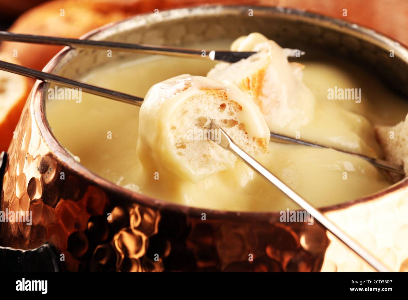 Gourmet Swiss fondue dinner on a winter evening with assorted cheeses ...