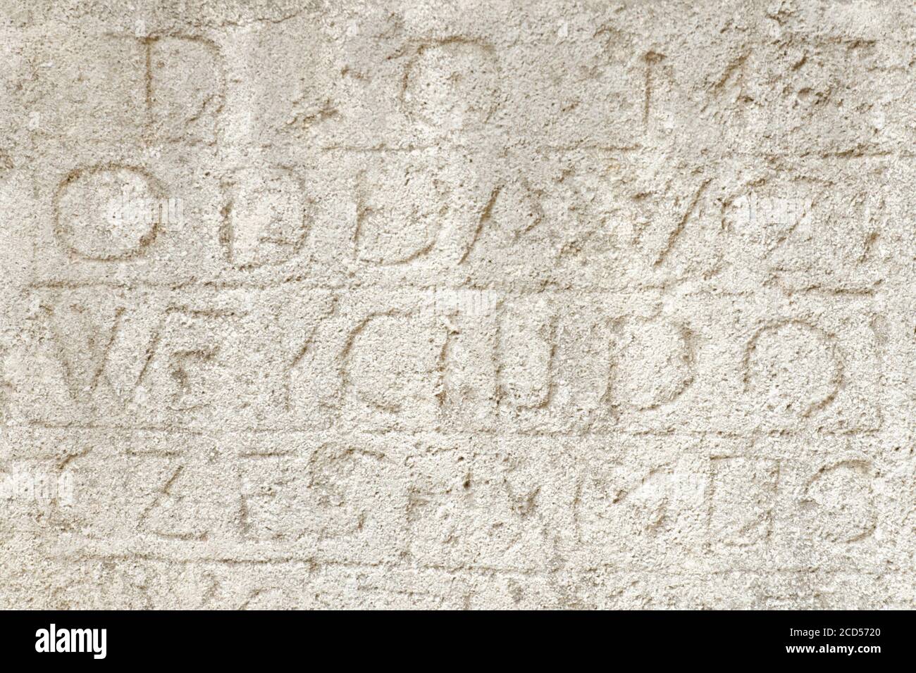 Backgrounds and textures concept. Faded Latin letters on an ancient ...