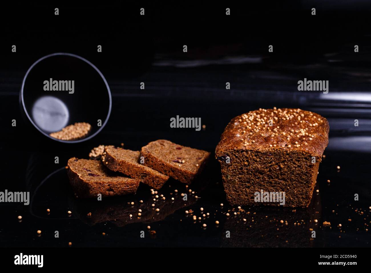 Homemade black bread on a black background. Photo in section Stock ...