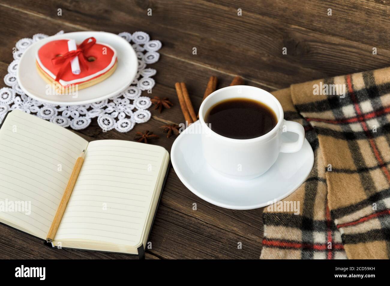 Cup of coffee, heart shaped cookies with message, notebook, pencil and ...