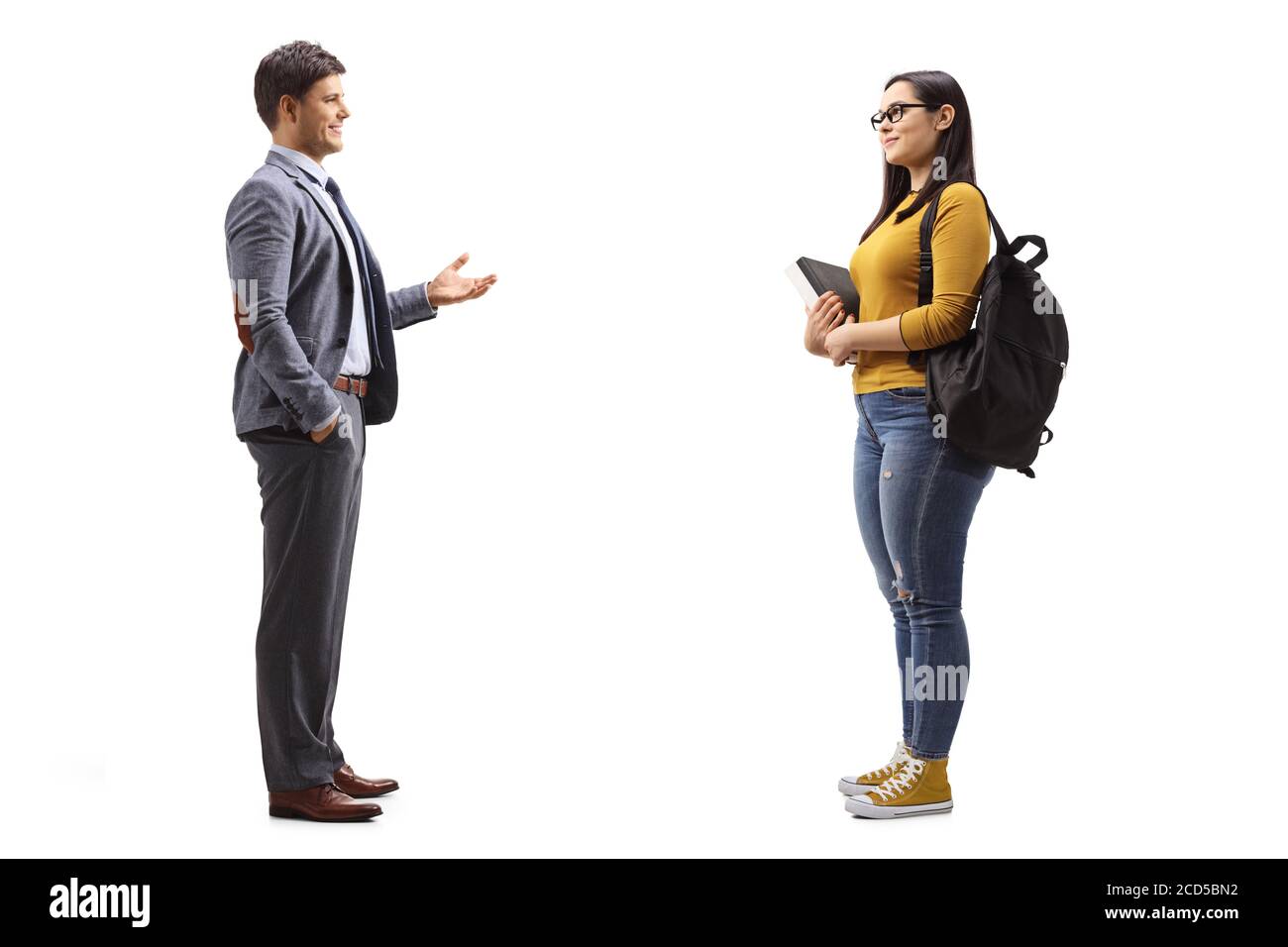 Full length profile shot of a female student and a man standing and ...