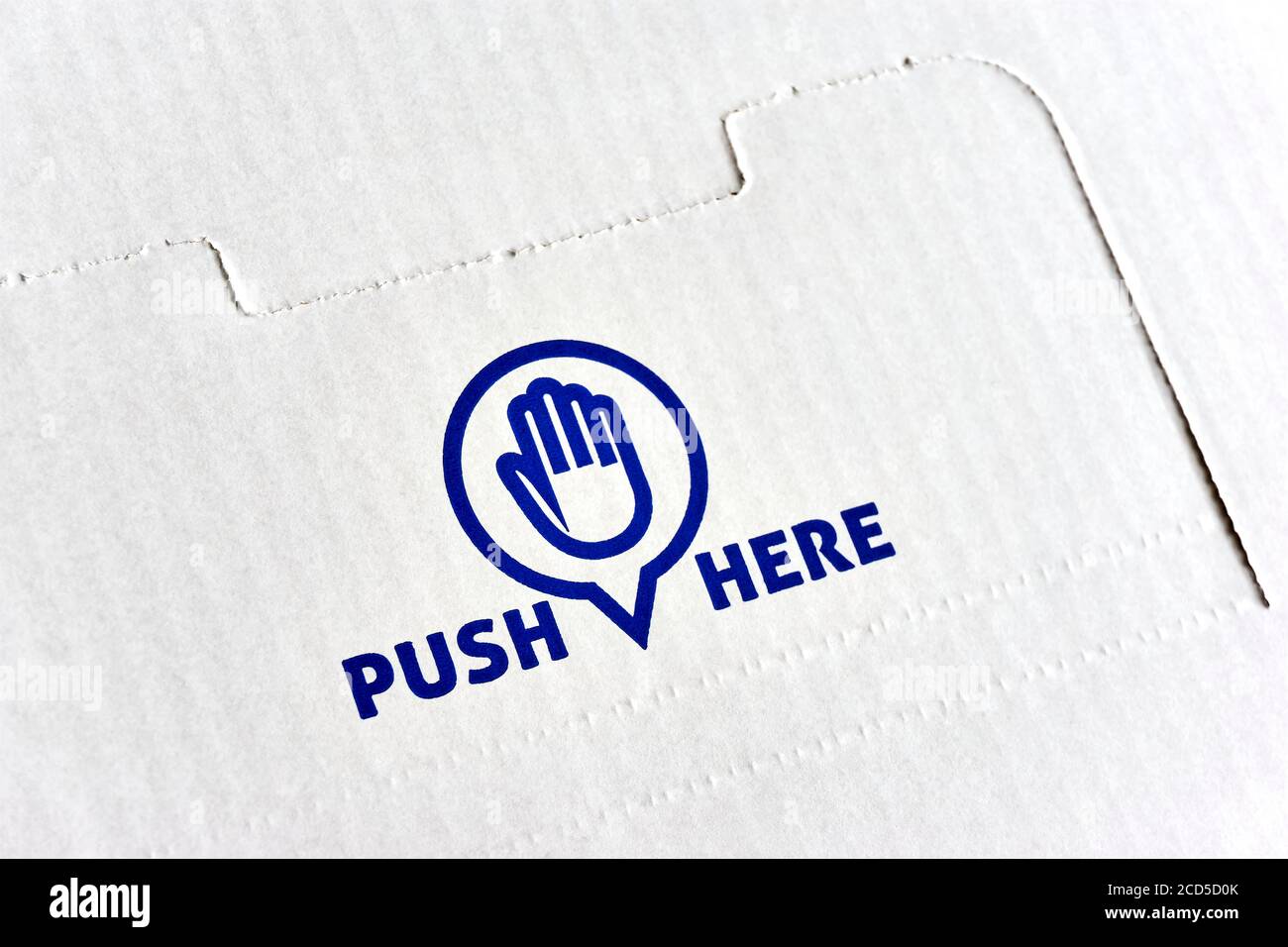 Closeup of white cardboard box with text push here. Packaging or moving ...