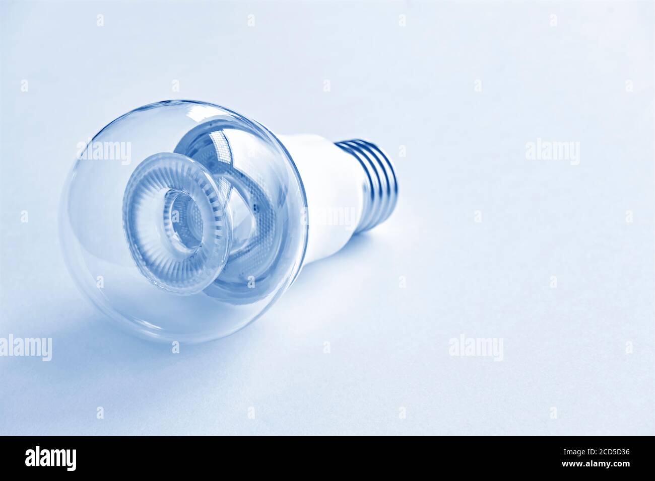 One transparent LED light bulb in monochrome blue. Energy saving ...