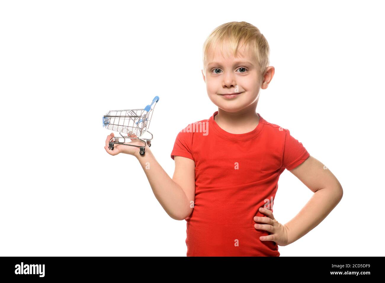 Shopping concept. Blond cute little smiling boy in red t-shirt holding ...