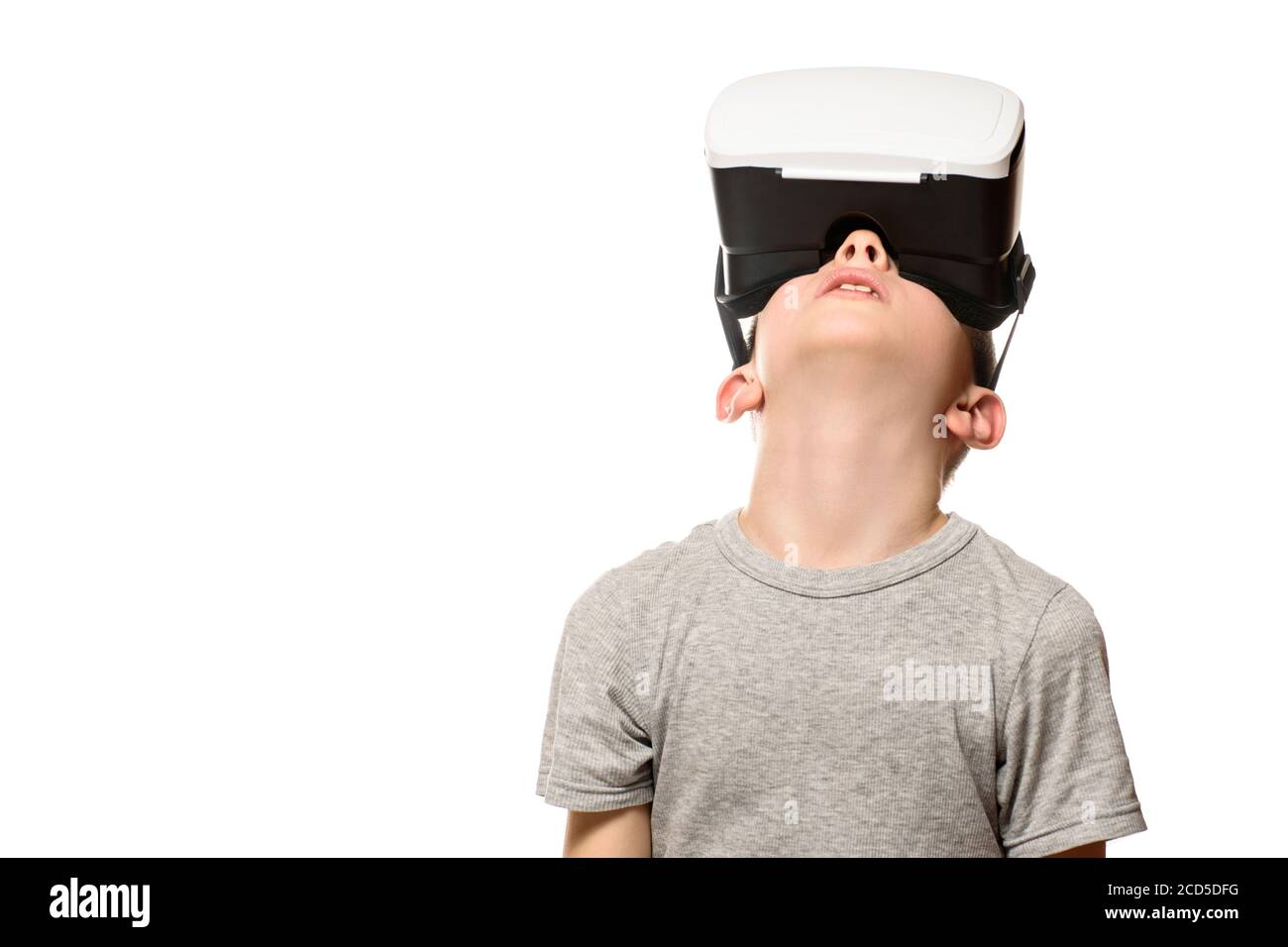 Boy experiencing virtual reality raising his head. Isolate on white ...