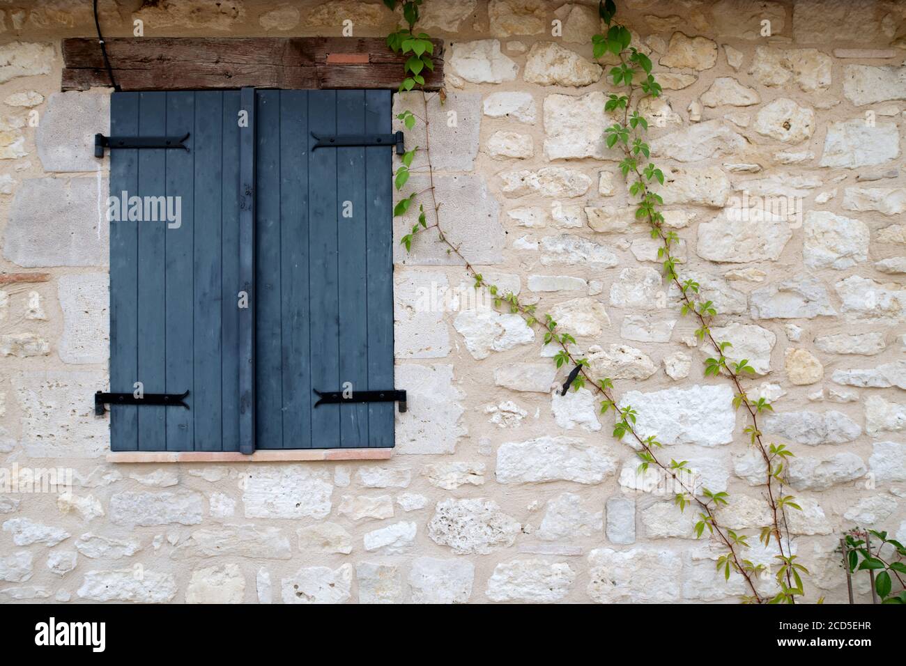 Dark grey window shutters closed in a stone wall surround Stock Photo ...
