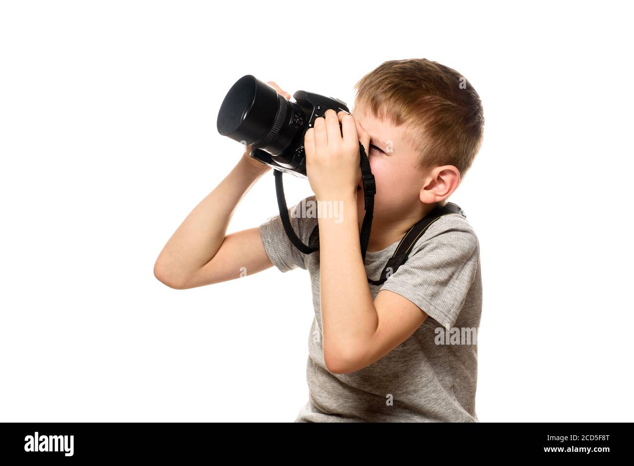 Boy takes pictures on the camera. Portrait. Isolate on white background ...