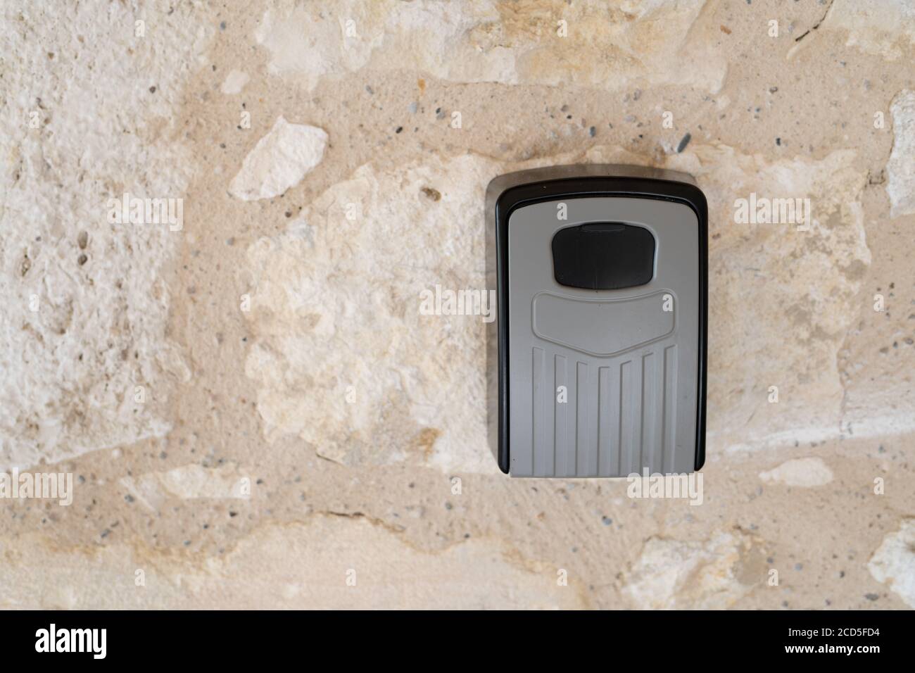 A key safe fitted to a stone wall Stock Photo - Alamy