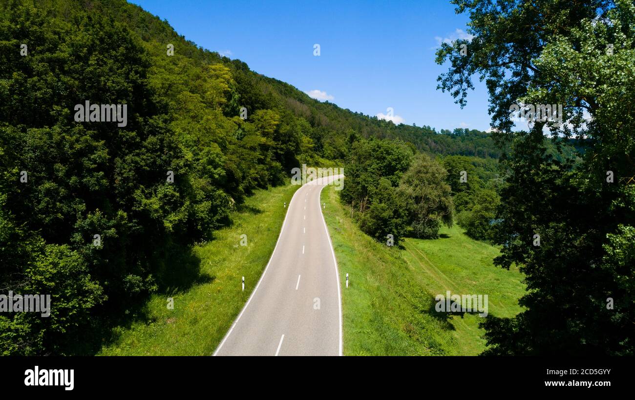 Aerial view of road through green landscape Stock Photo - Alamy