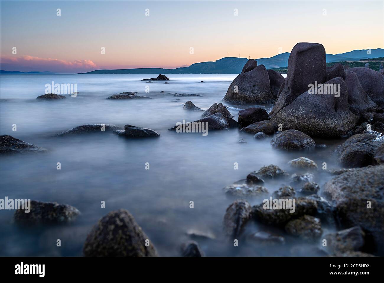 Long exposure in the rockery on the beach of Balikliova Stock Photo - Alamy
