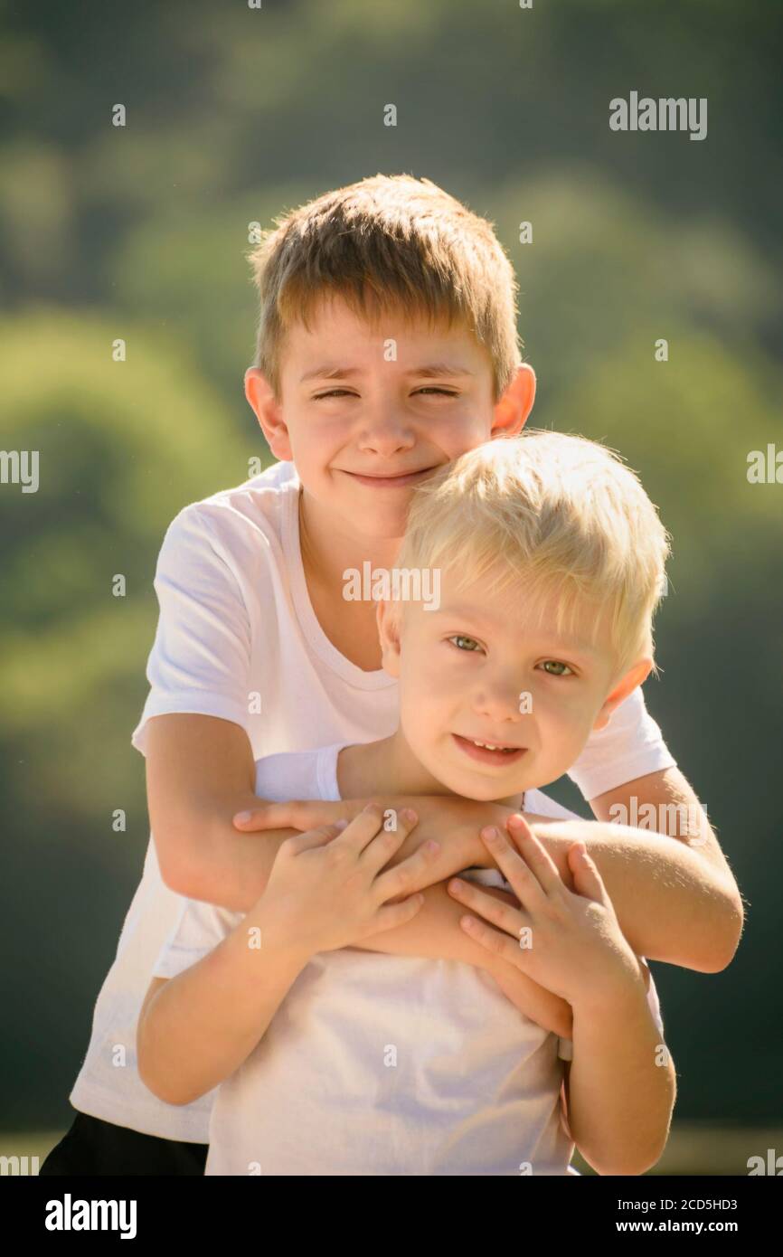 Two little boys are hugging outdoors. Concept of friendship and ...