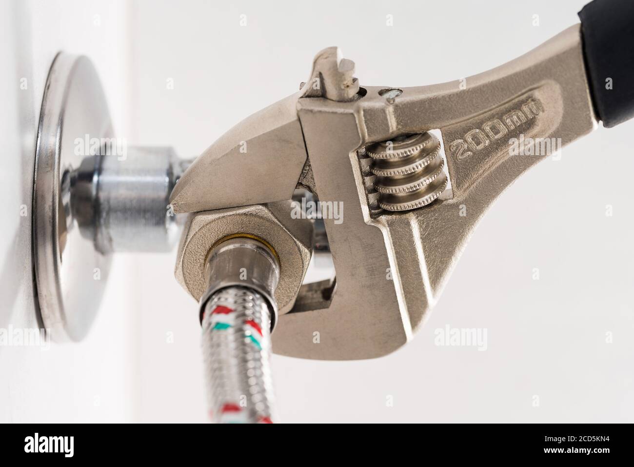 Domestic plumbing connections hoses. Using an adjustable wrench Stock ...