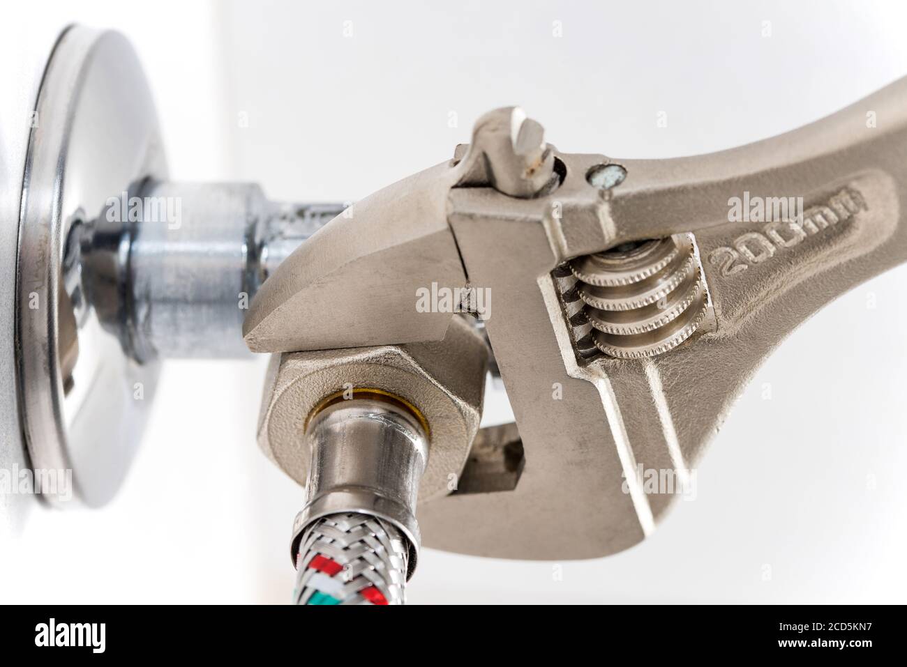 Domestic plumbing connections hoses. Using an adjustable wrench Stock ...