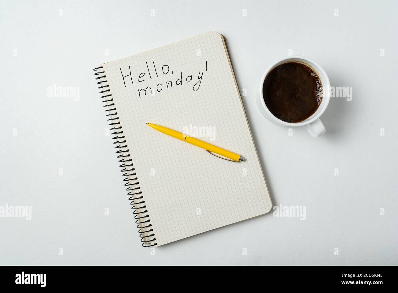 Hello monday written on notebook over white background. Morning coffee ...
