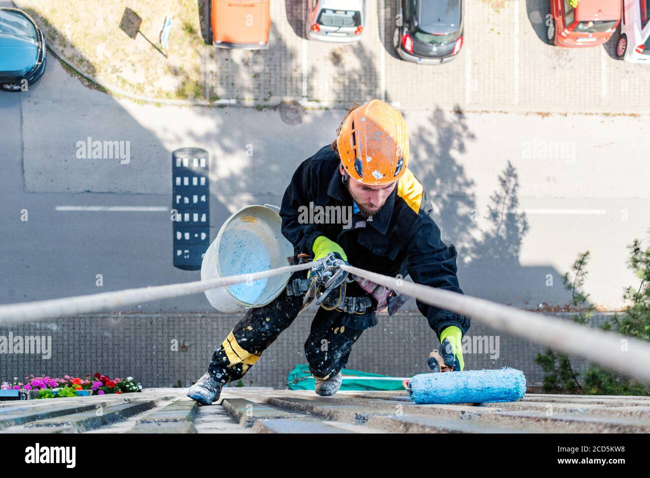 Male worker hanging on rope access and height construction project ...