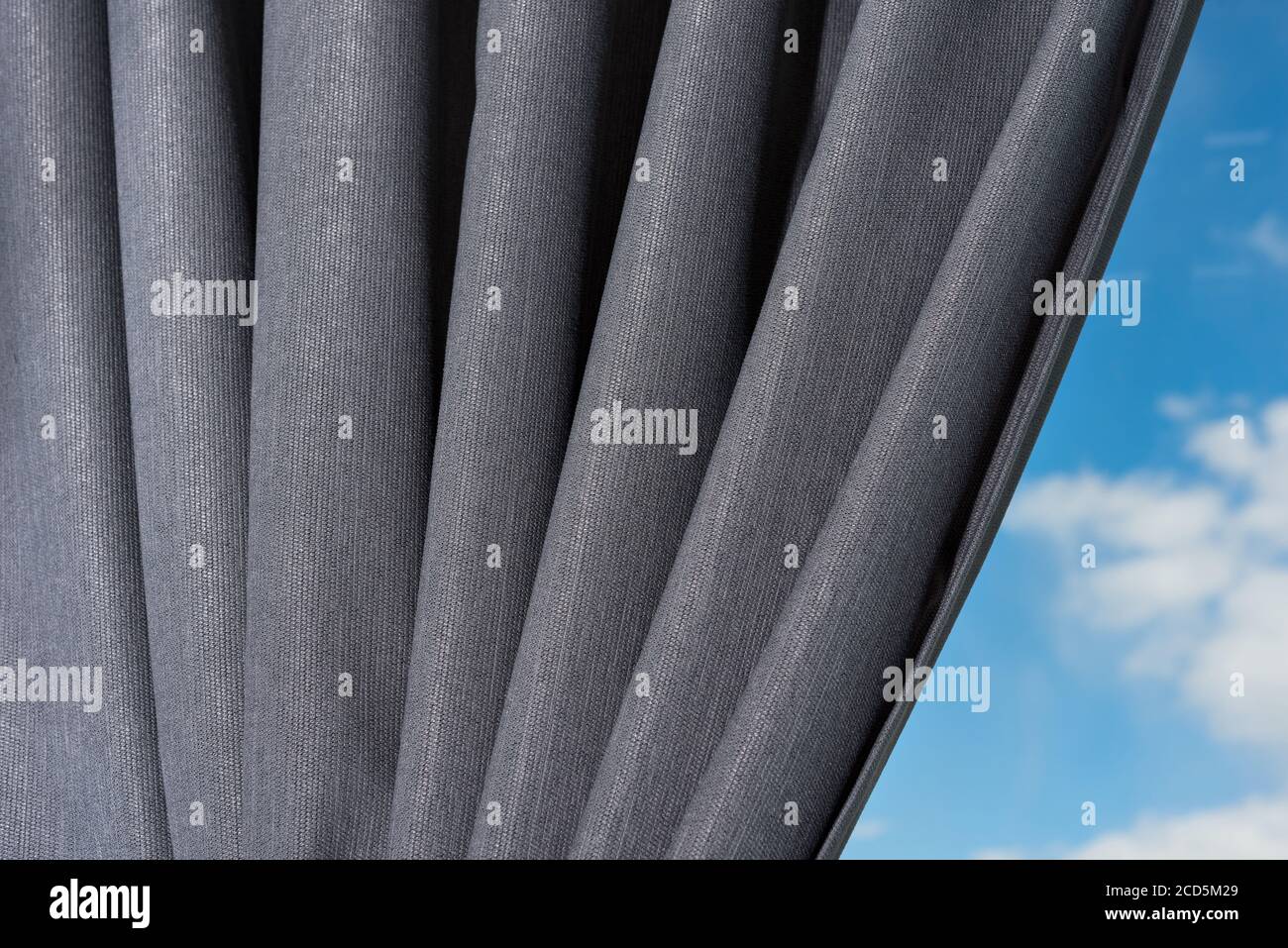 Closeup view of curtain in thin and thick vertical folds made of dense ...