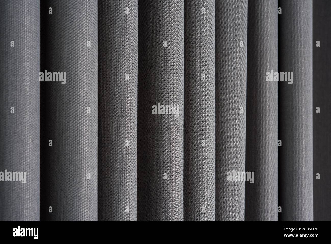 Closeup view of curtain in thin and thick vertical folds made of dense ...