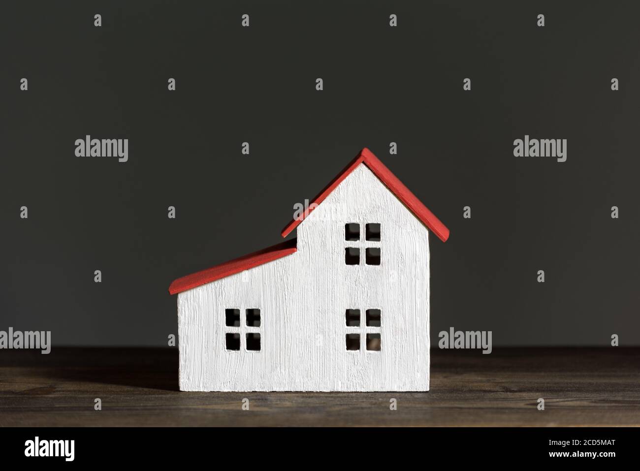 Miniature house on black background. Front view. Home construction ...