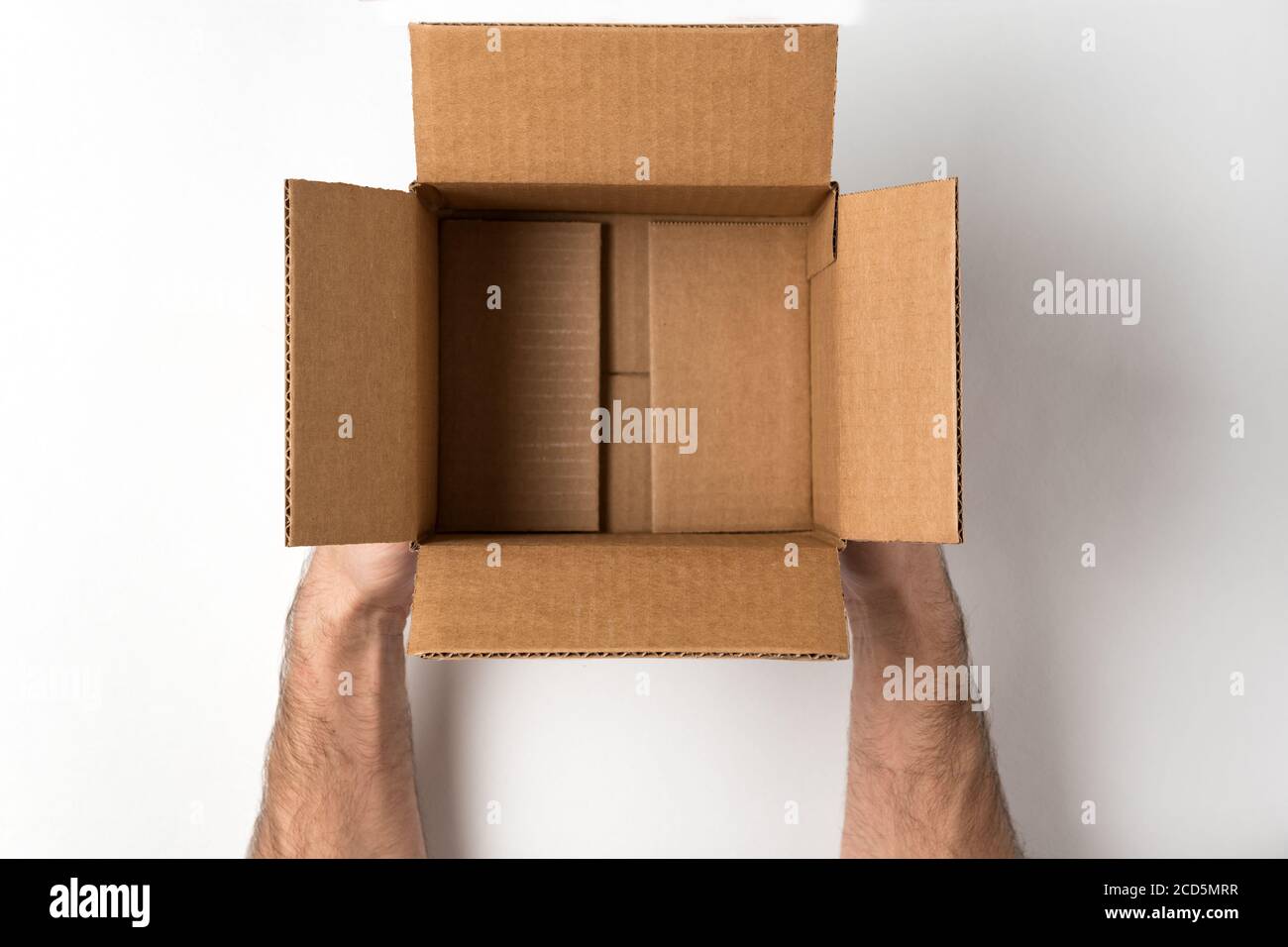 Male hands holding open empty cardboard box. White background Stock ...