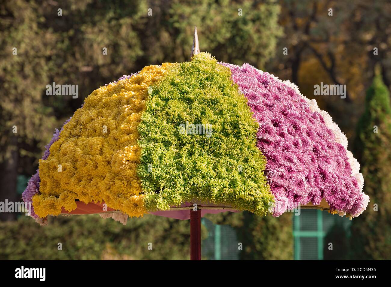 Landscape design. Sculptures of flowers. Umbrella decorated with ...