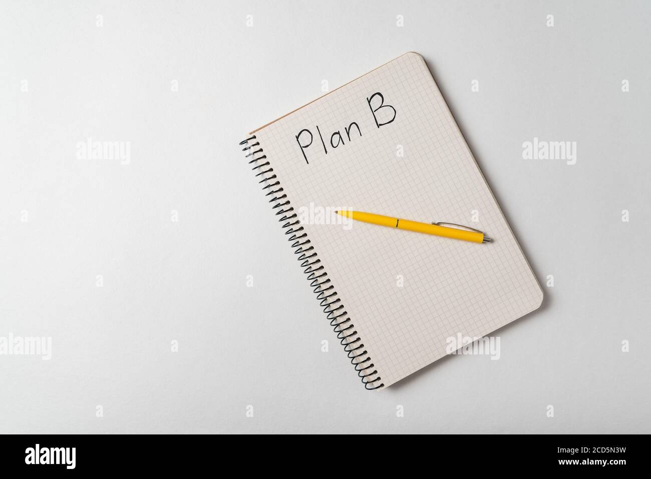 Plan B text in copybook. Notepad and pen on white background top view ...