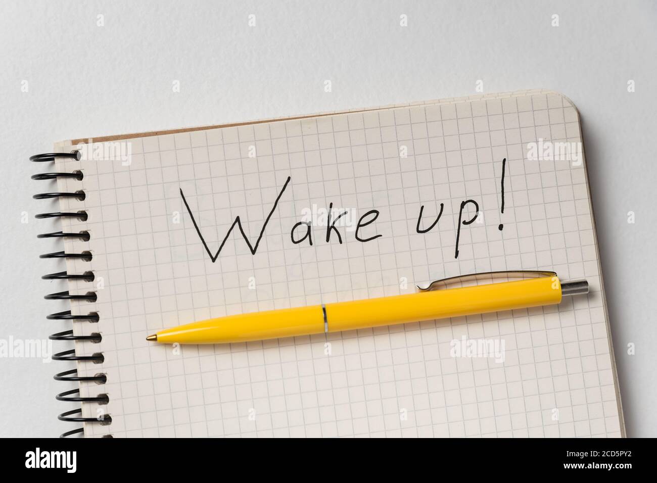 Notepad with words Wake UP on white background. Handwritten text close ...