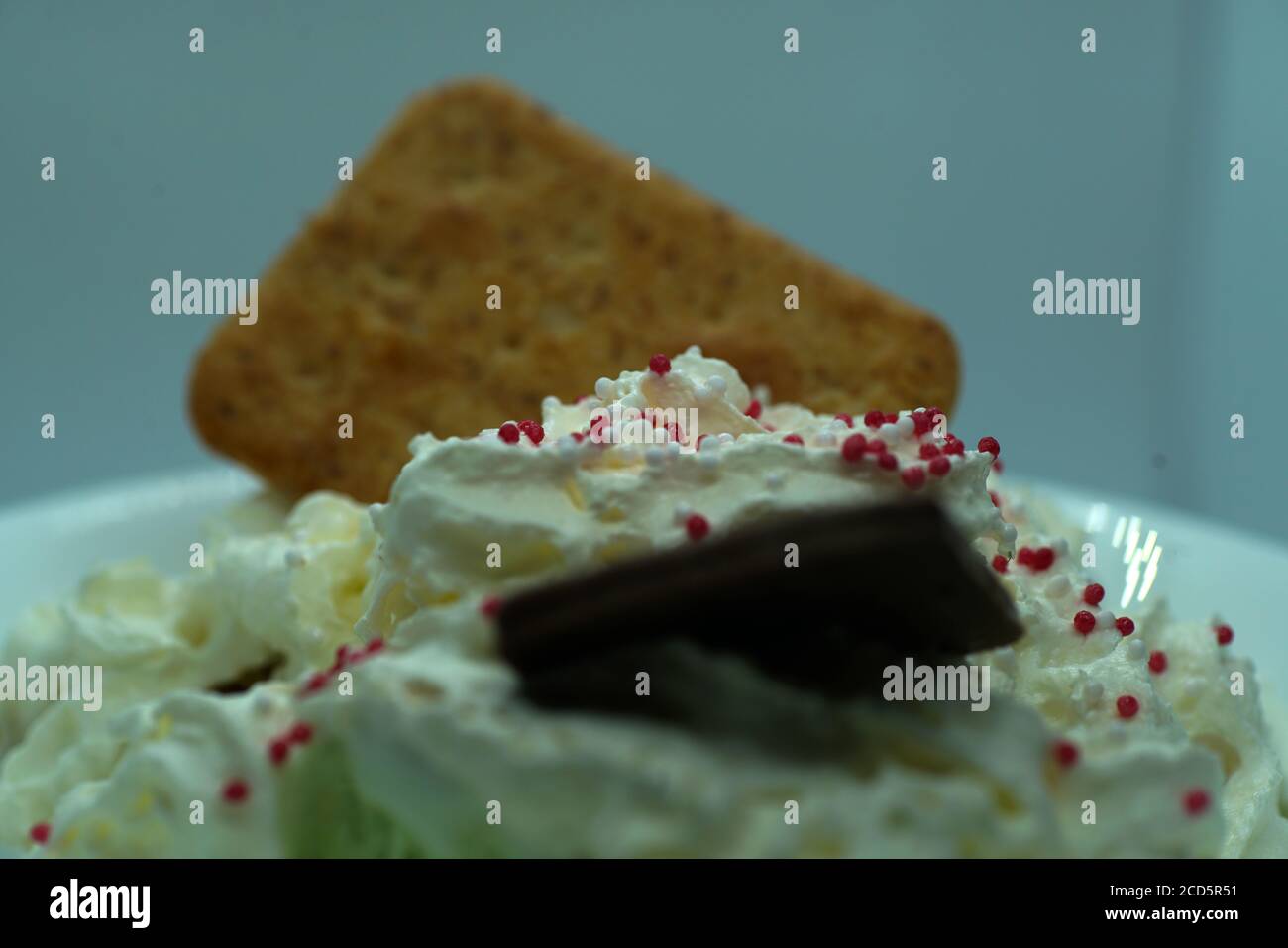Closeup shot of whipped cream with red sprinkles and a biscuit Stock ...