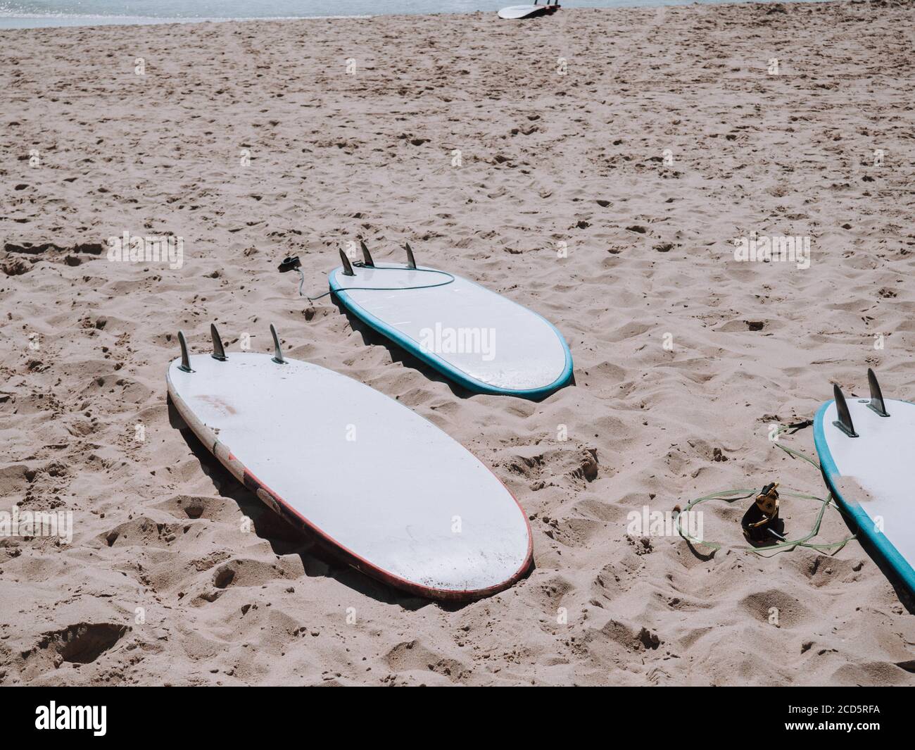 Shot of surfboards on sand Stock Photo - Alamy