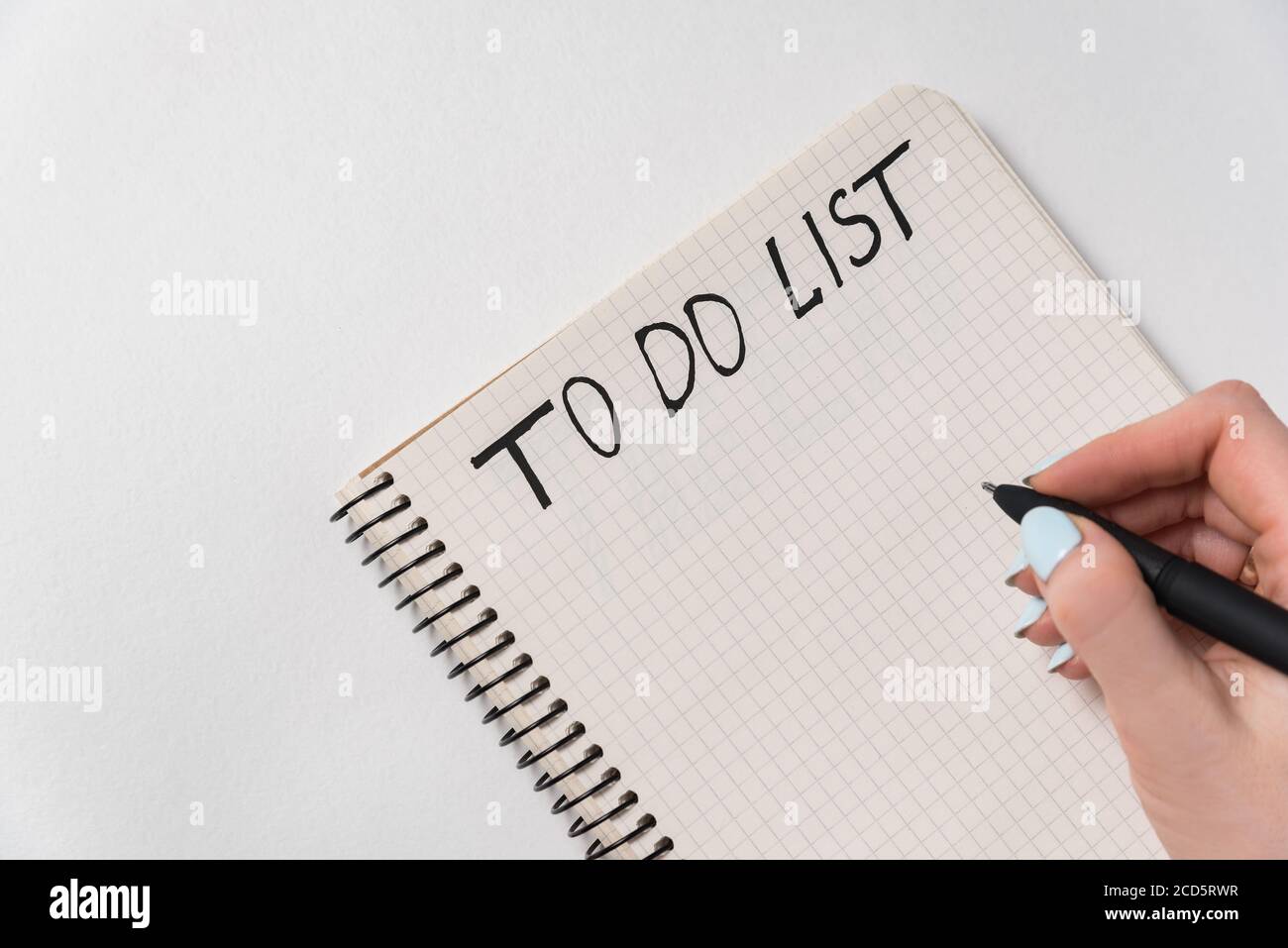 Female hand writing a To-do list. Notebook on white background. Plan ...