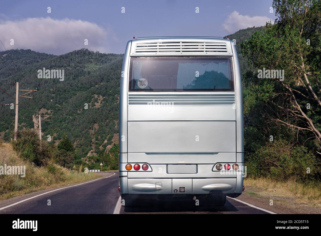 Rear side of bus. Behind white bus on nature background. Place for text ...