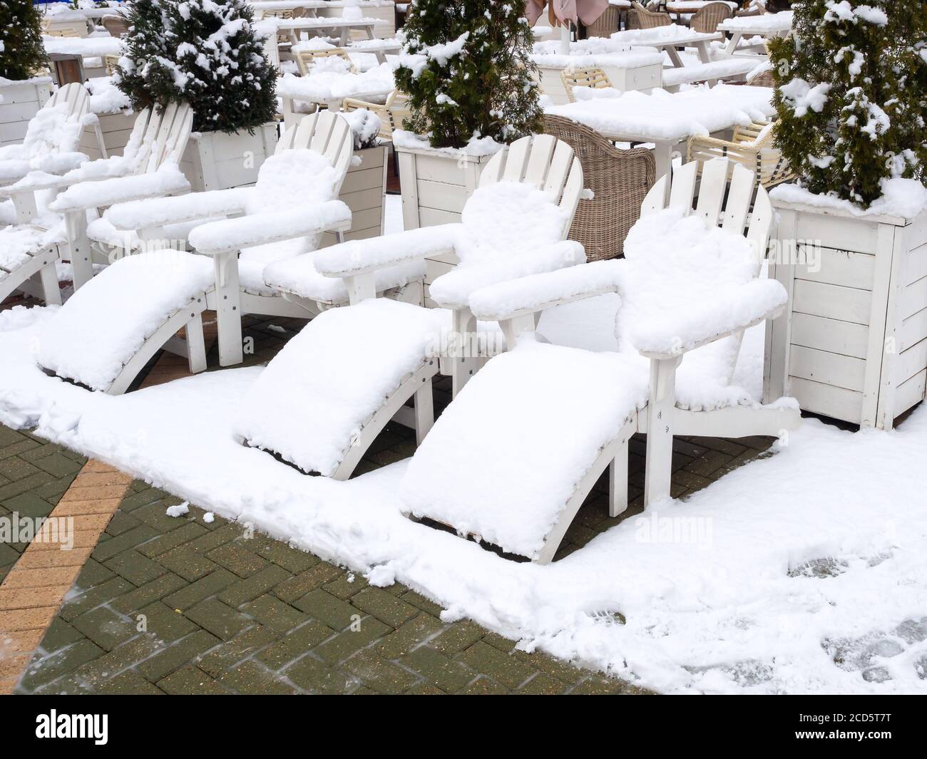Wooden white sun chairs stand in a row strewn with snow Stock Photo - Alamy