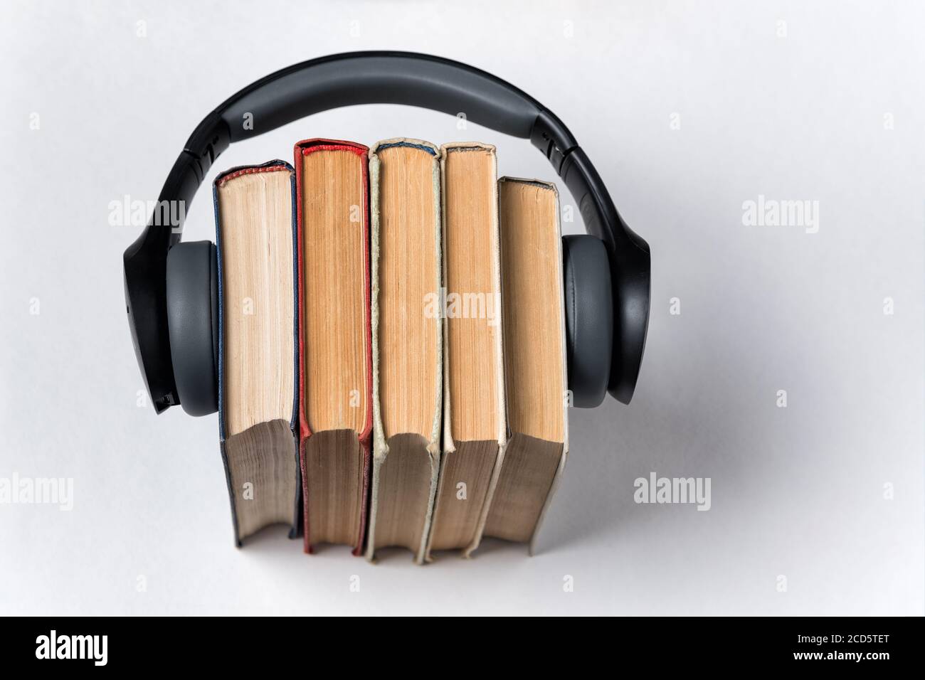 Old books and headphones on a white background. Audio library concept ...