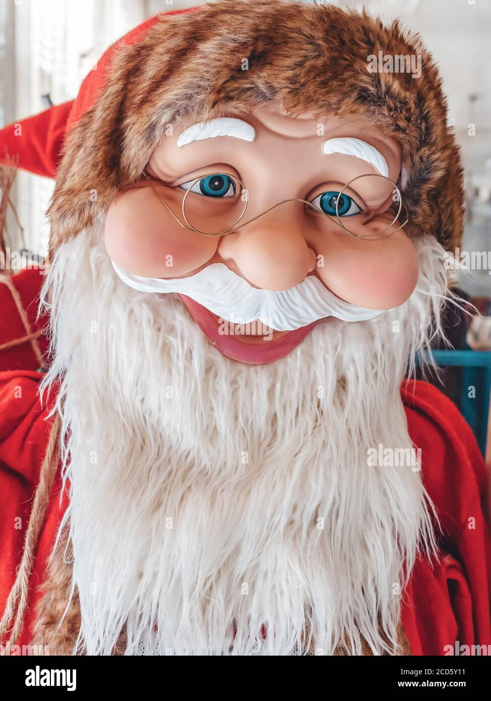 Toy rubber santa claus head with blue eyes and wire goggles on the nose ...