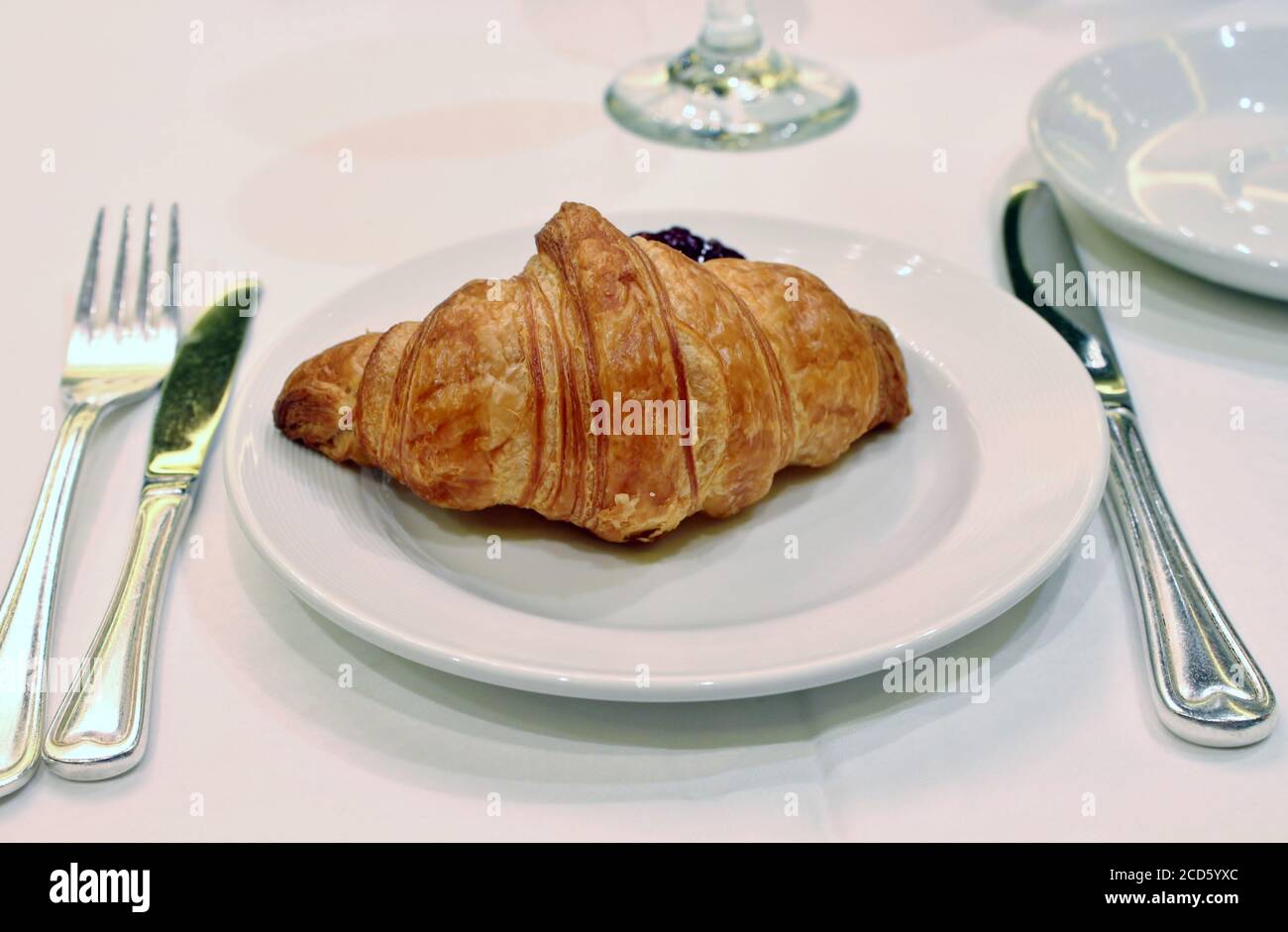 Baked croissant on a white plate Stock Photo - Alamy